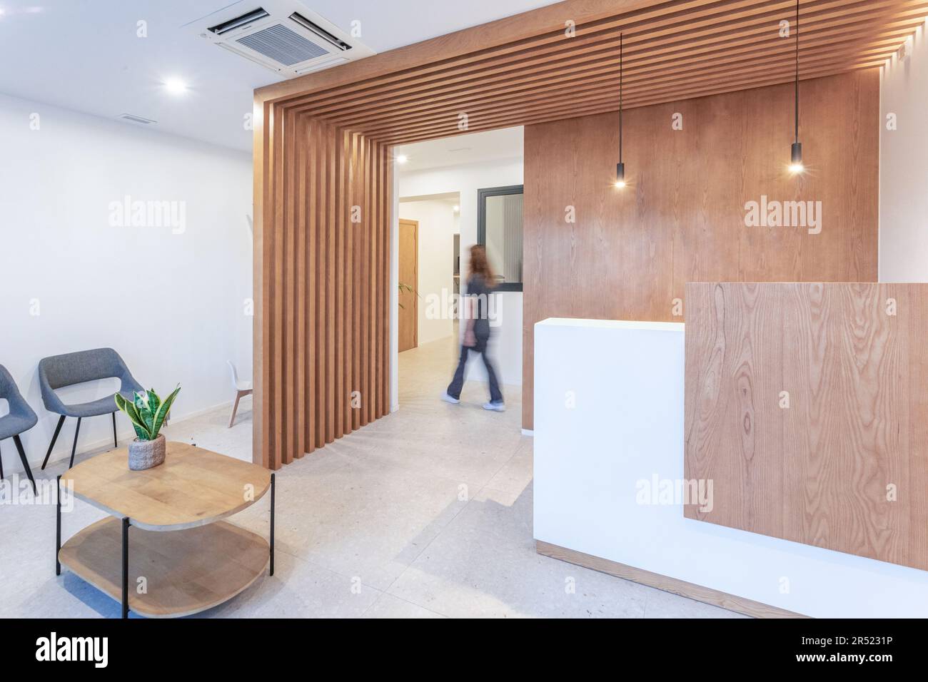 Interior of contemporary clinic hall with table and chairs placed near ...