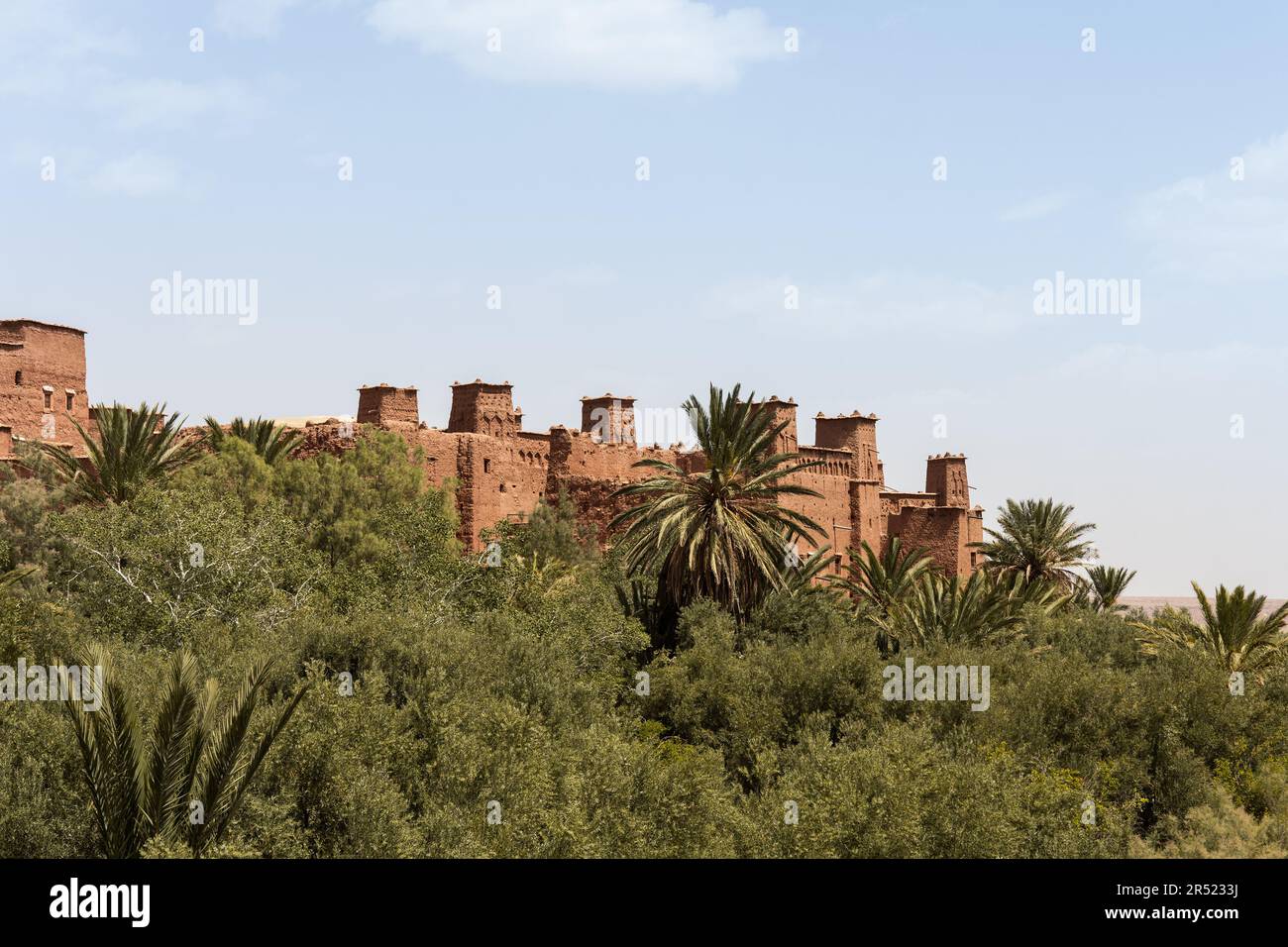 Front below of historic Moroccan castle rising above lush tropical ...