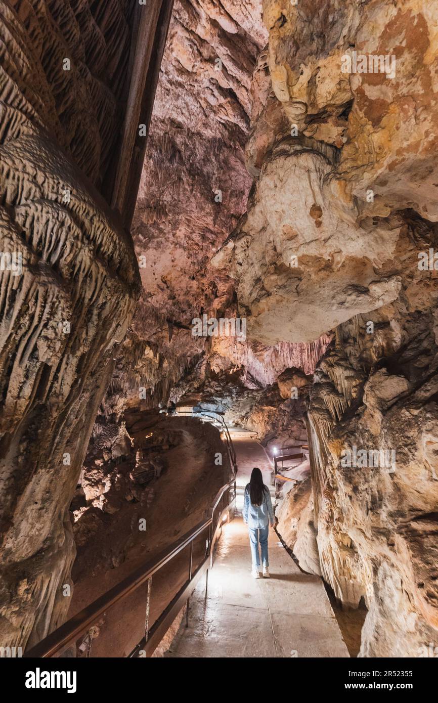 Back view of unrecognizable female tourist with black hair walking in ...