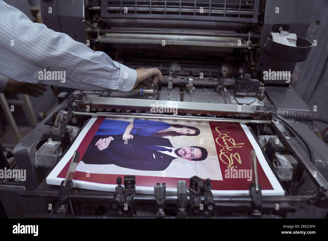 A Jordanian specialist follows the process of printing posters with ...