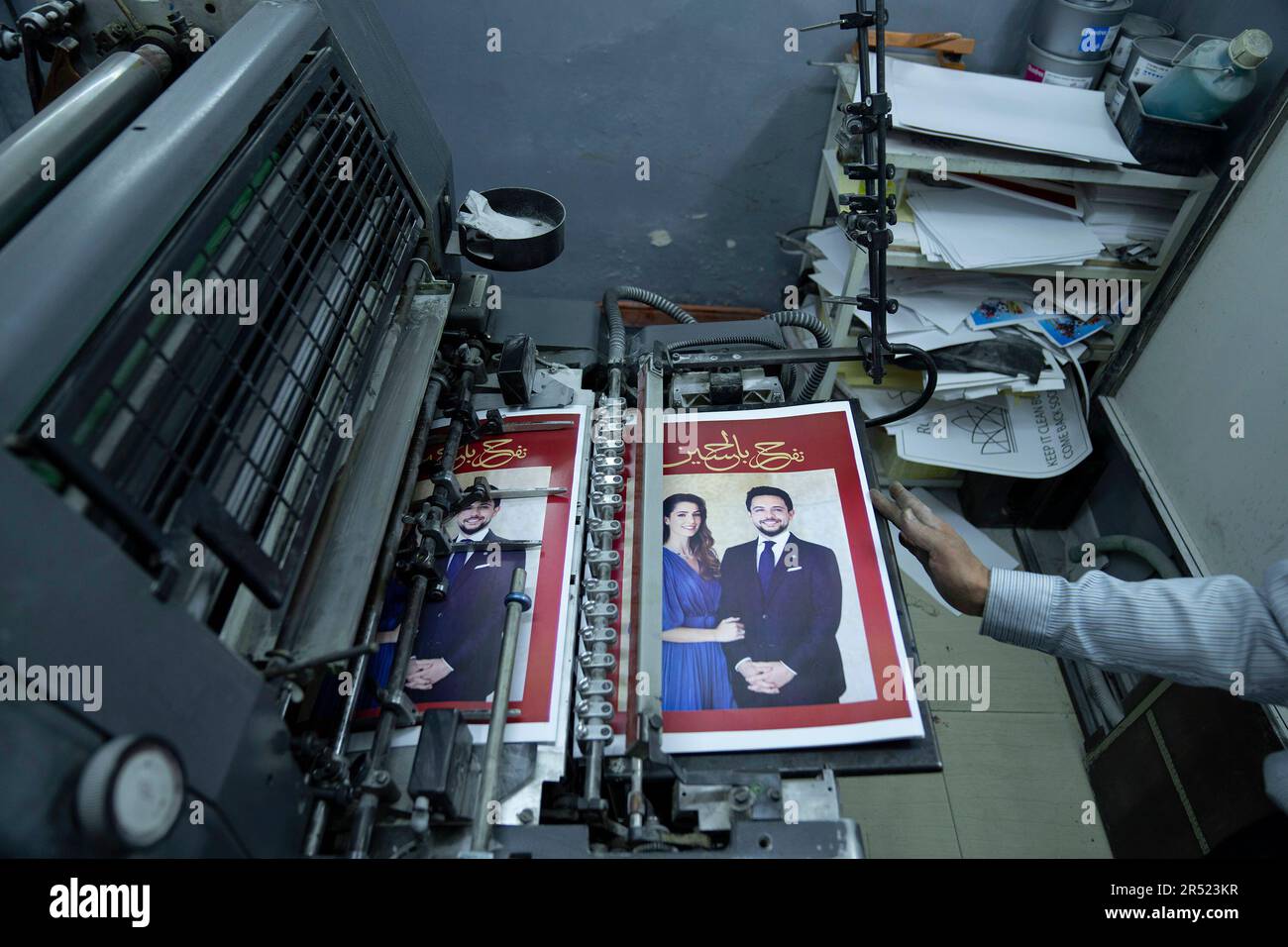 A Jordanian specialist follows the process of printing posters with ...