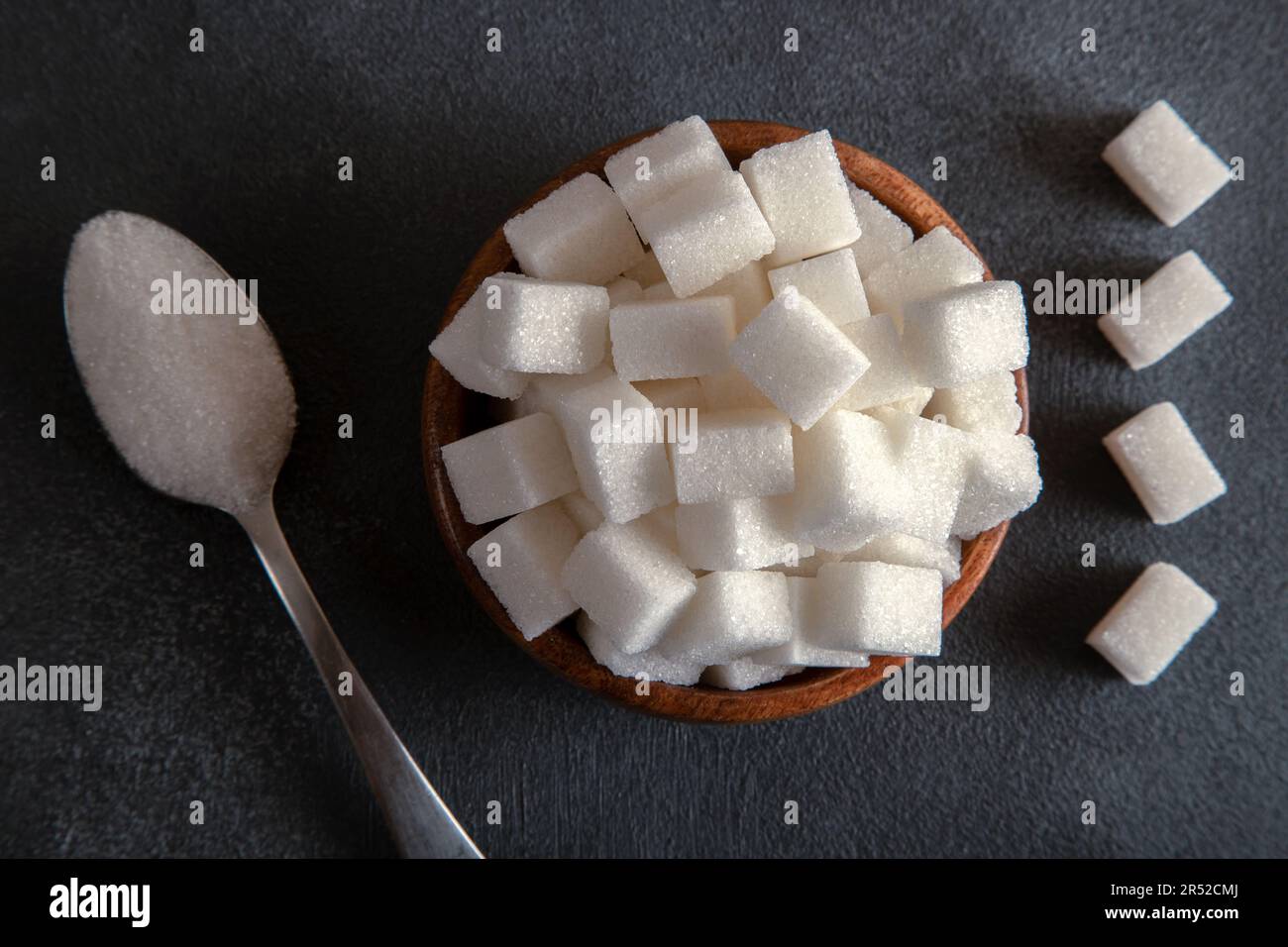 Cube sugar and granulated sugar on black background,closeup Stock Photo ...
