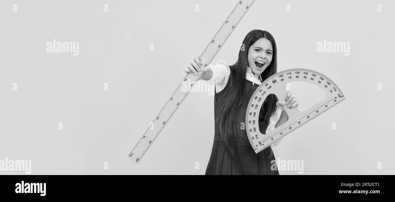 emotional child hold math protractor and ruler in school on yellow ...