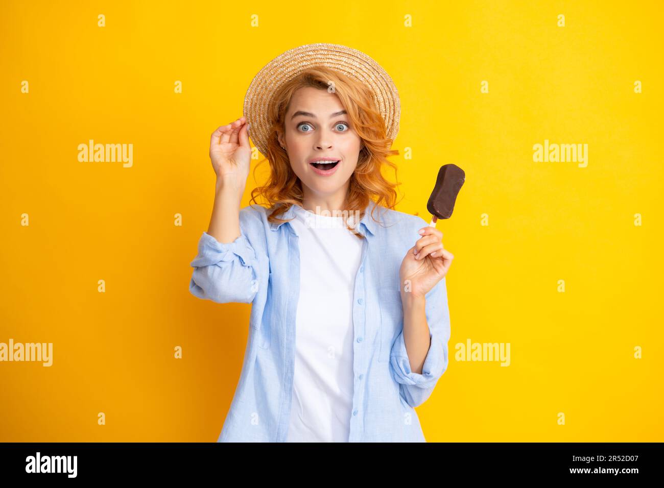 Girl posing with chocolate ice cream on yellow isolated background ...