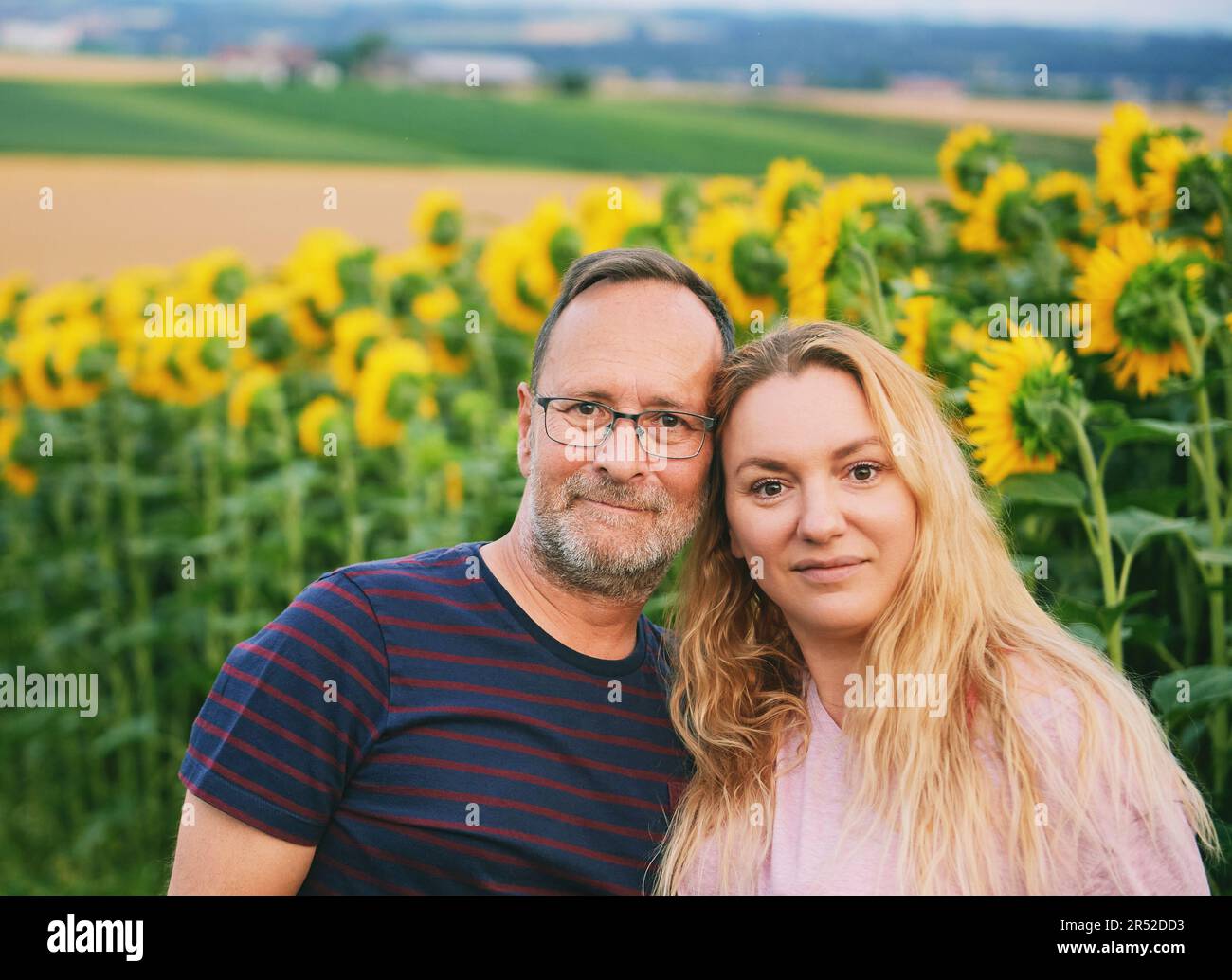 Outdoor portrait of middle age couple enjoying nice day in countryside ...