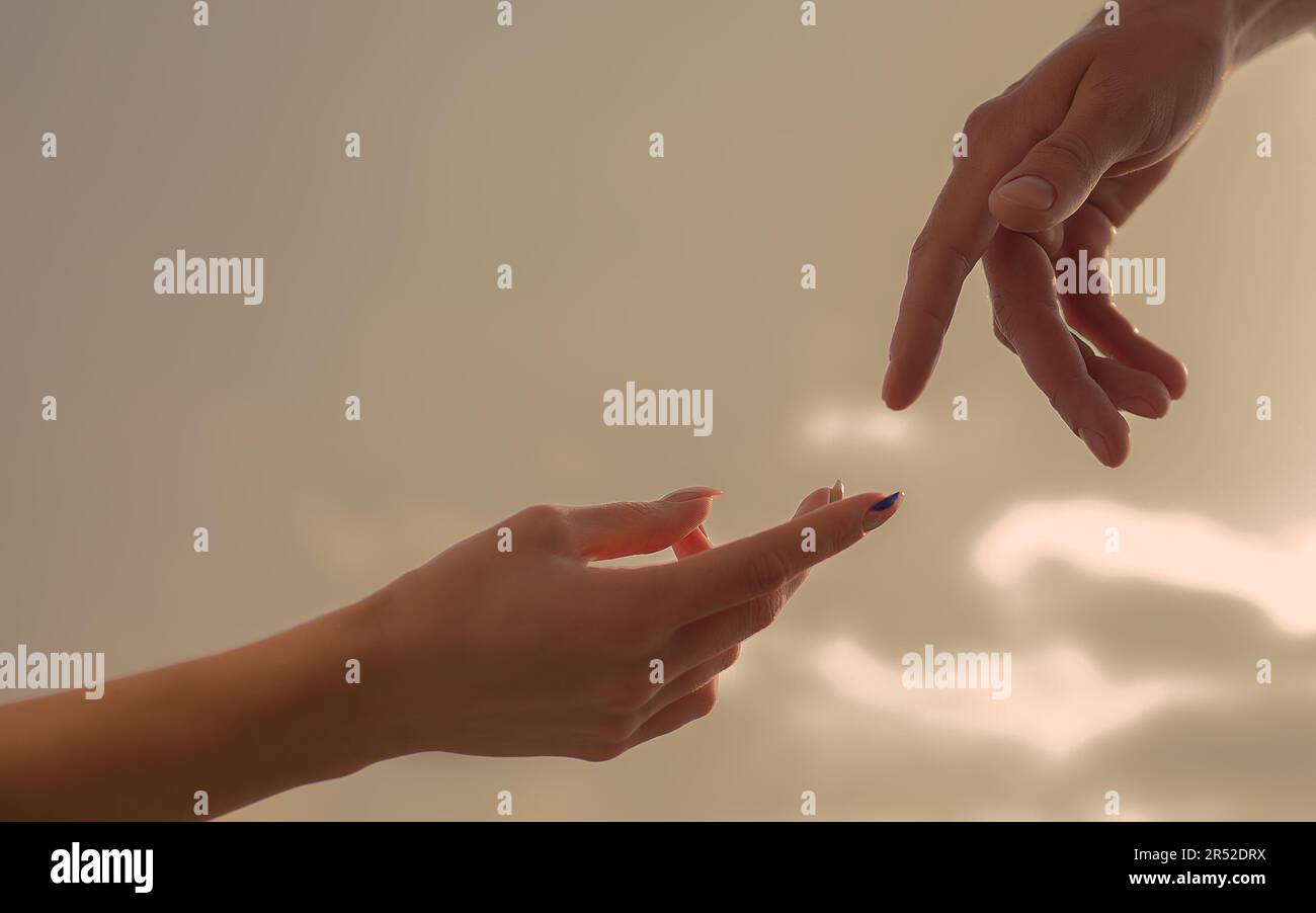 A woman's and a man's hand reaching out to each other Stock Photo - Alamy