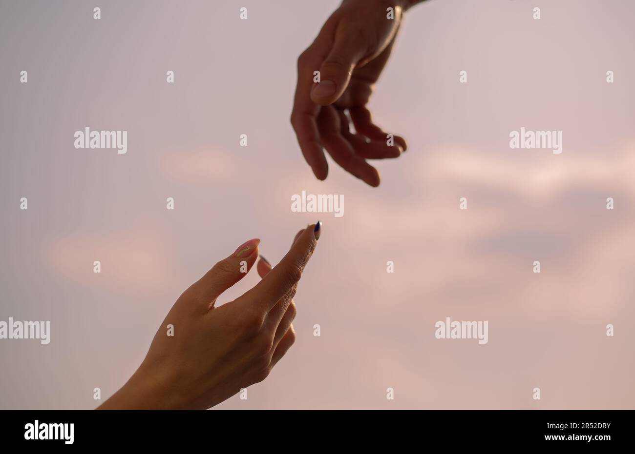 A woman's and a man's hand reaching out to each other Stock Photo - Alamy