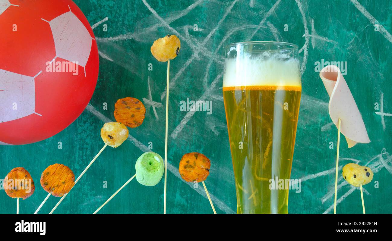 Soccer or football concept with soccer ball, glass of beer, pork ...