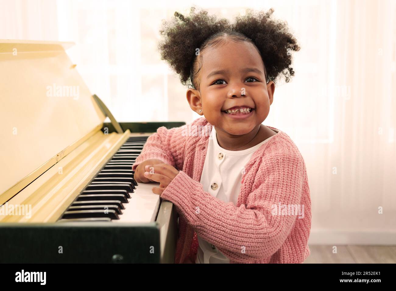 Kid playing piano, Daughter in piano class, Happy kid playing piano ...