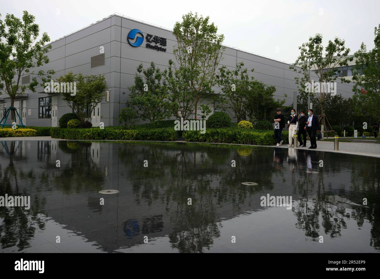 People walk by SinoHytec, a manufacturer of fuel cell systems in China ...