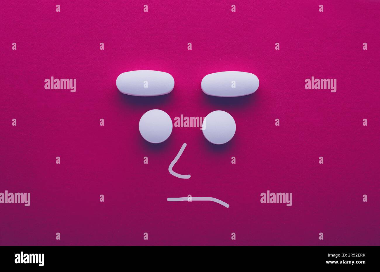 sad face made with medicine drug pills on pink background Stock Photo ...