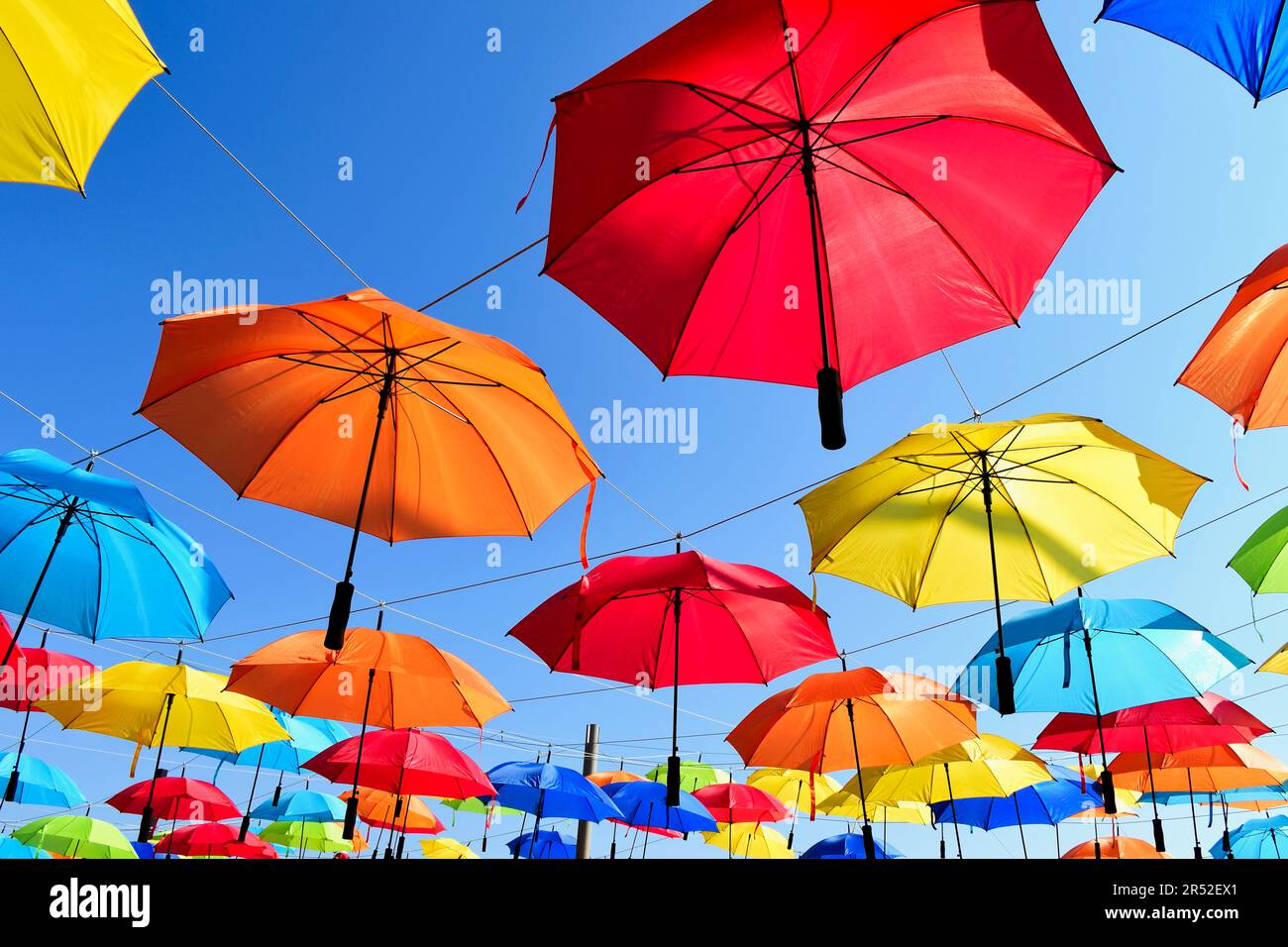 colorful parasol sun protection. bright umbrellas suspended overhead on ...