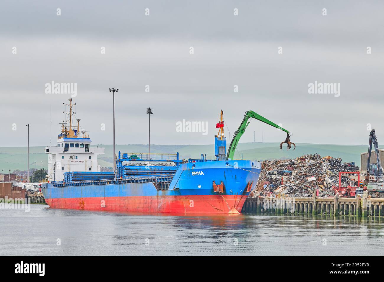 The ship Emma uses its grab crane to load scap metal from the quayside ...
