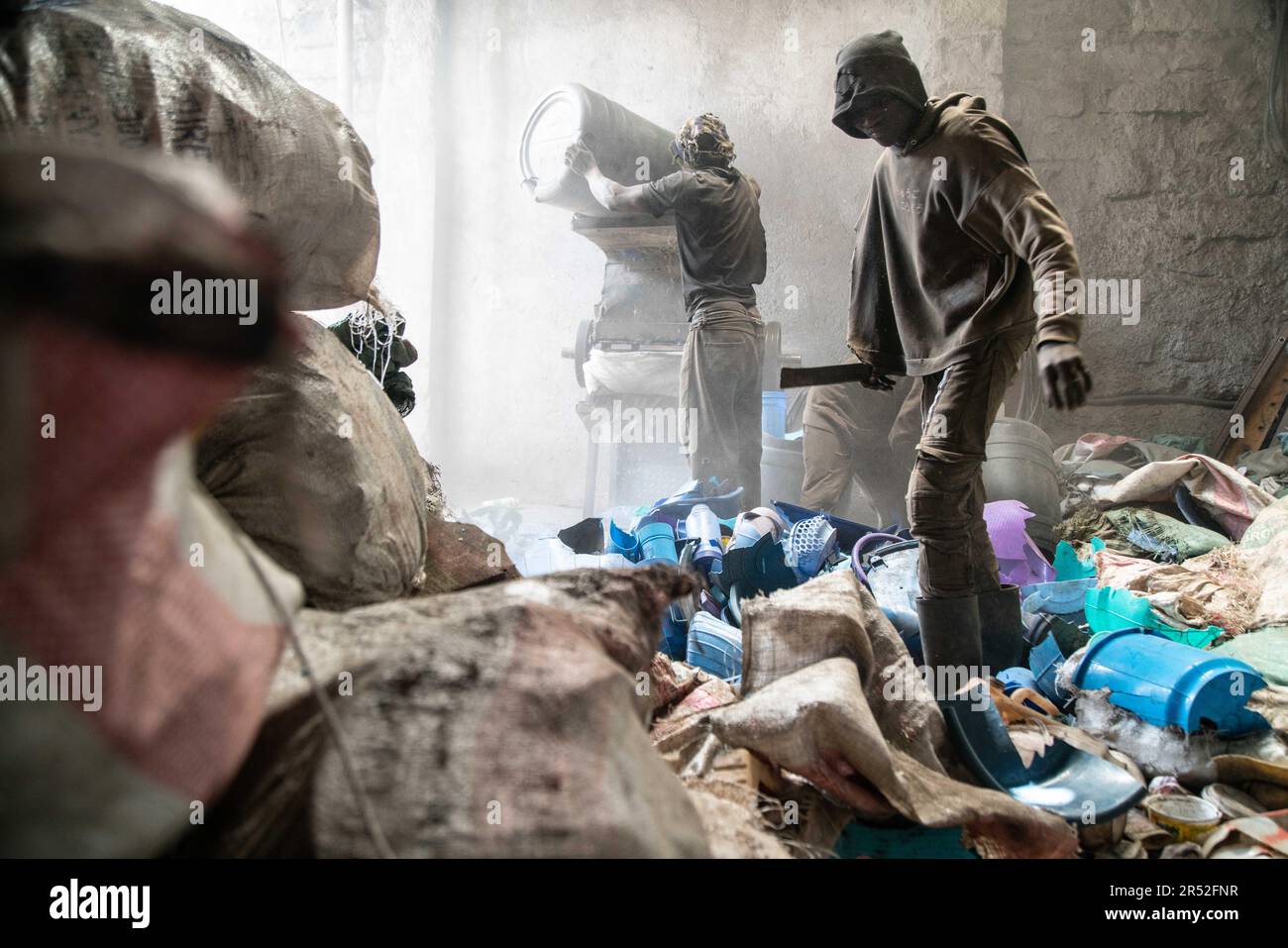 Nakuru, Kenya. 31st May, 2023. Workers fill plastic waste into a ...