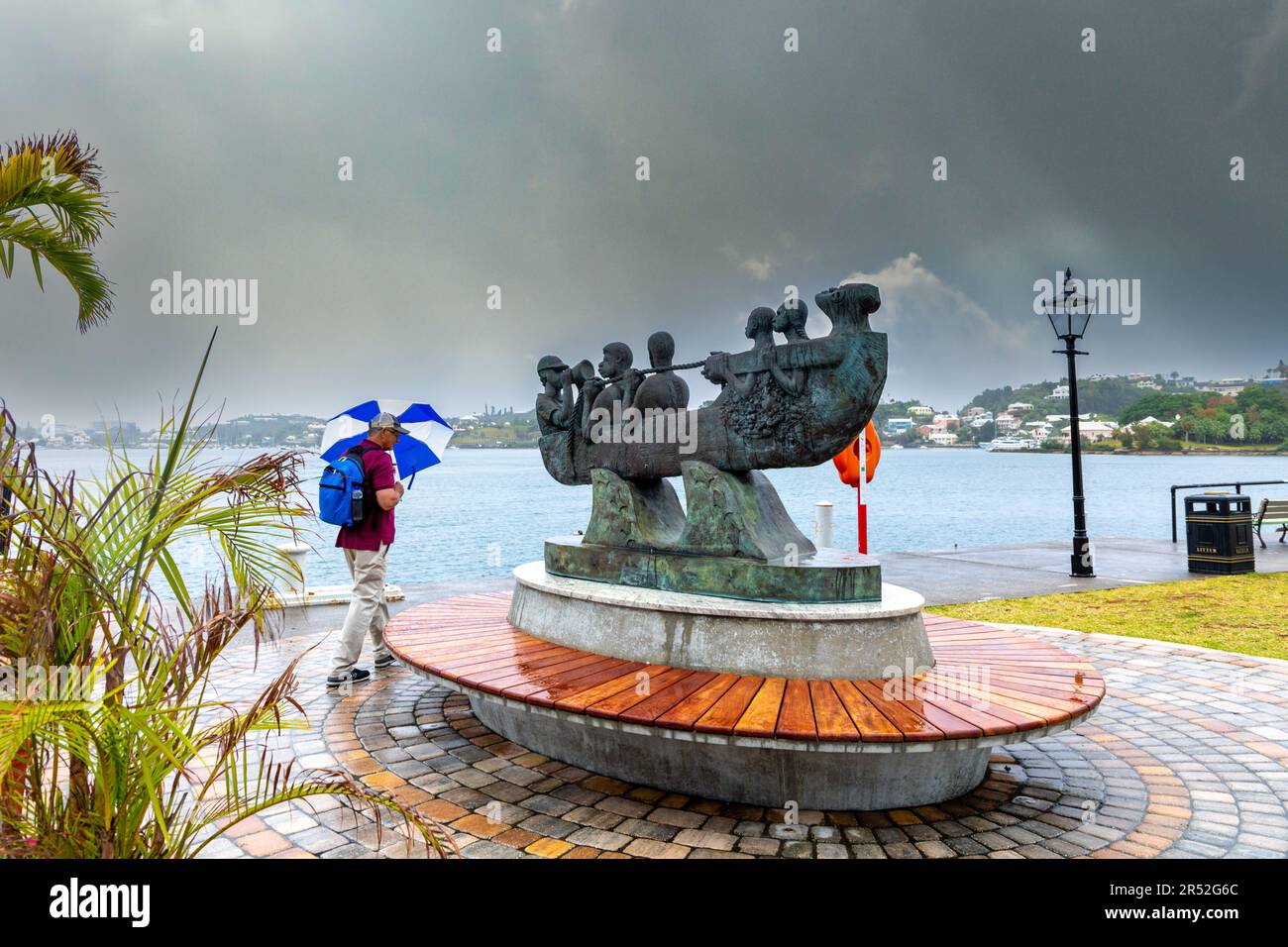 A visitor admires 'Against Da Tide,' a bronze sculpture created by ...