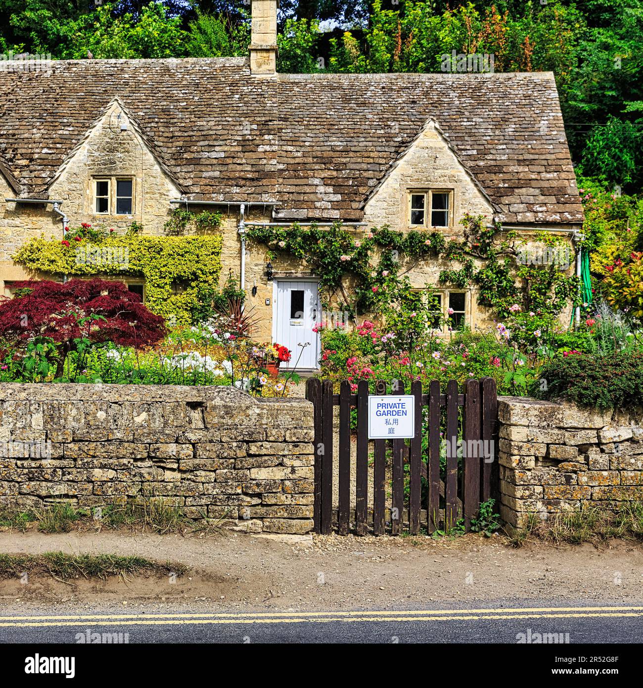 Typical stone house with front garden, sign saying Private Garden ...