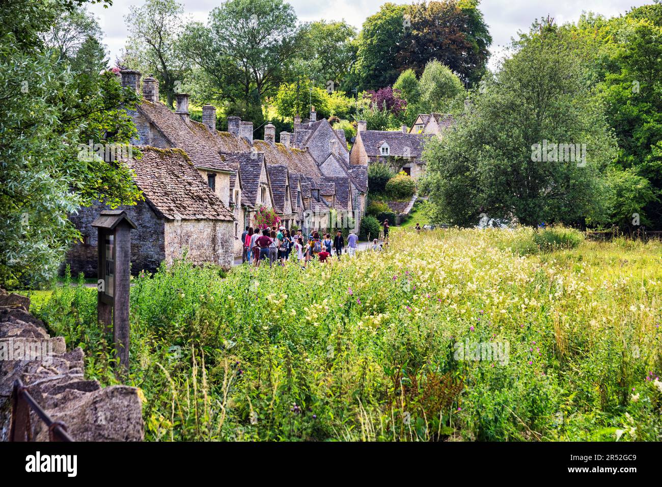 Picturesque village with heritage-protected houses, tourist group in ...