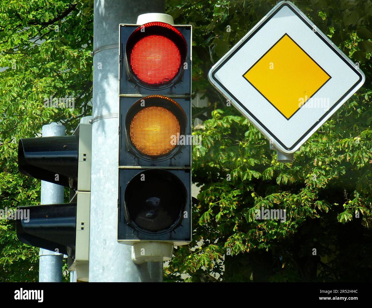Traffic light red/yellow with right of way sign Stock Photo - Alamy
