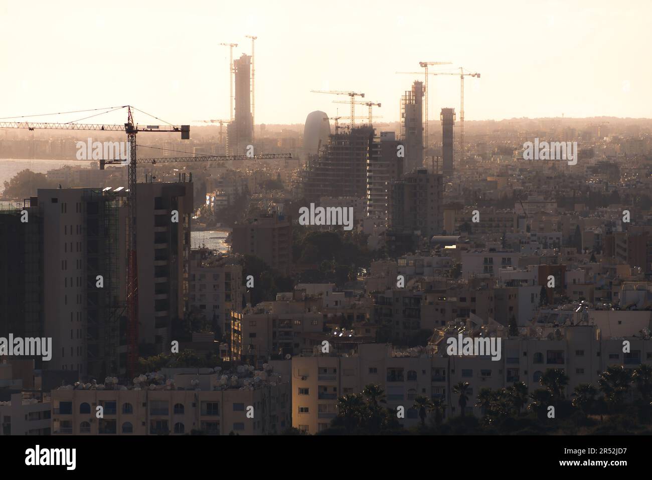 Silhouettes of high-rise buildings under construction in evening ...
