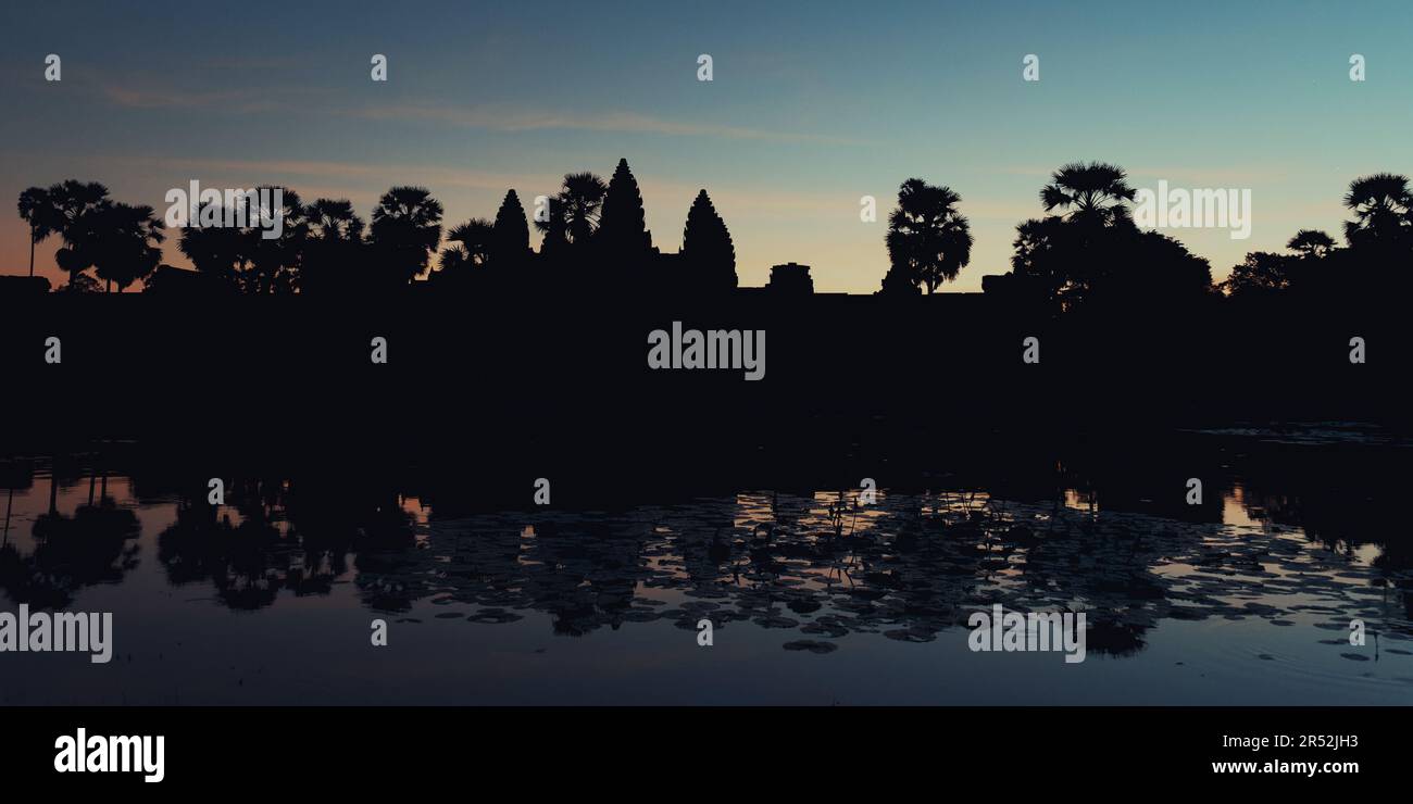 Atmospheric Cambodian landscape featuring Angkor Wat, as the dark dawn ...