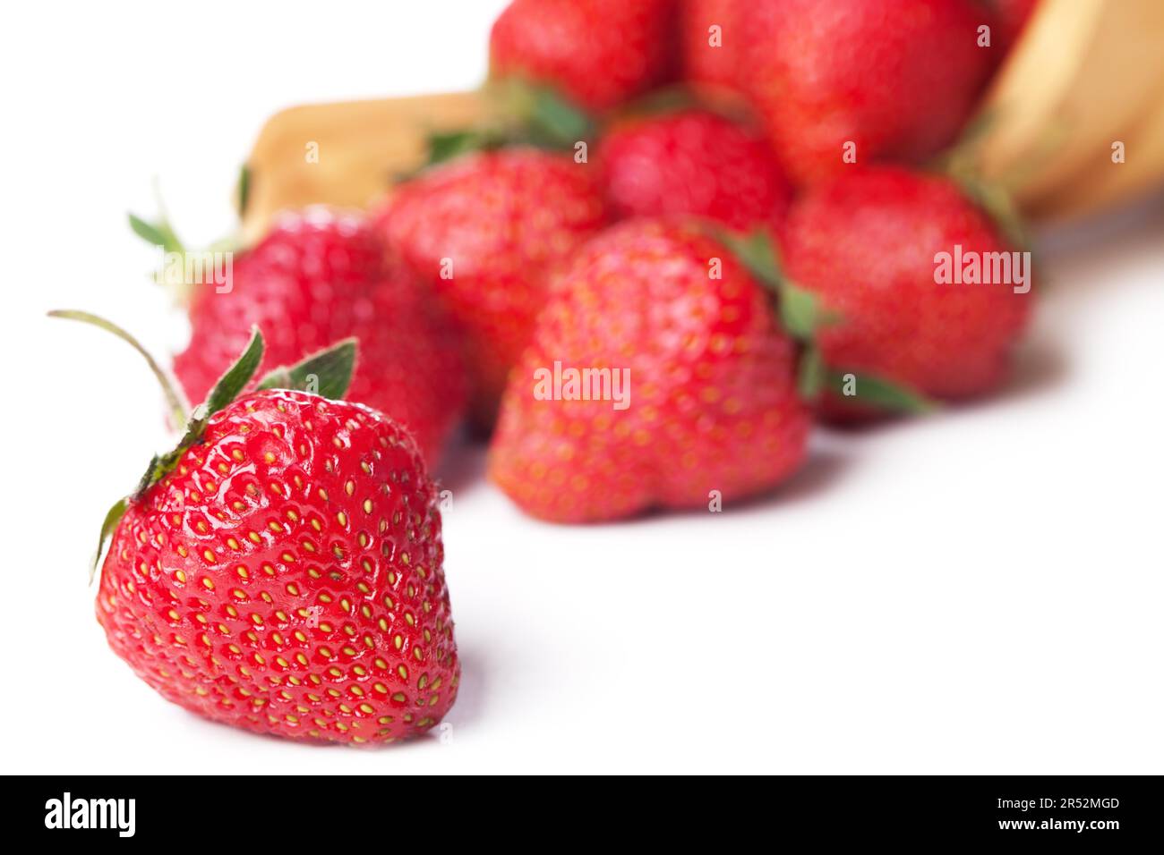 strawberries in basket hanging on a white background Stock Photo - Alamy