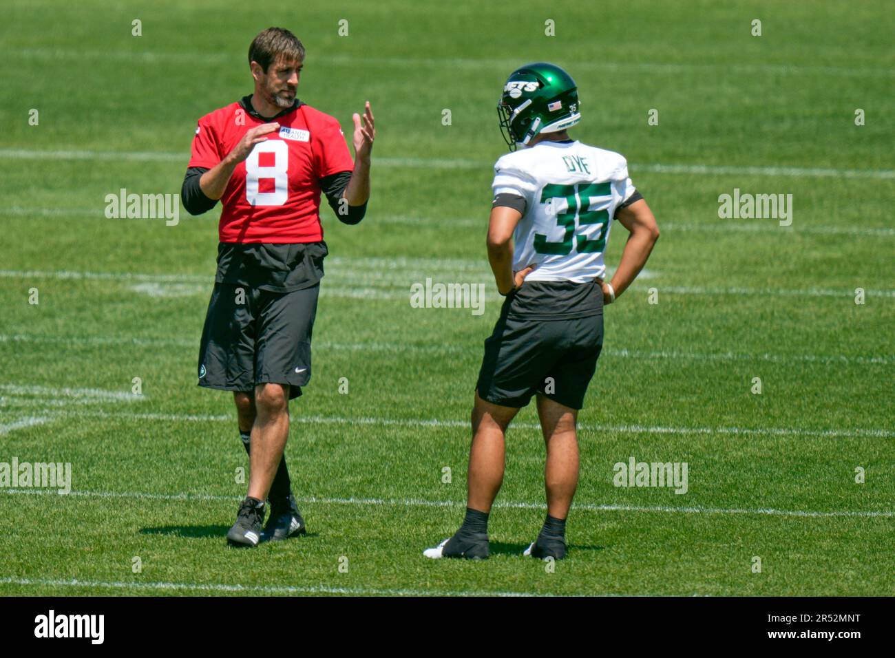 New York Jets quarterback Aaron Rodgers (8) talks with Marquis Dye ...
