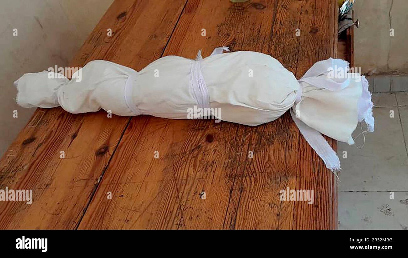 The body of a child is wrapped in white burial cloth in the Foster Home ...