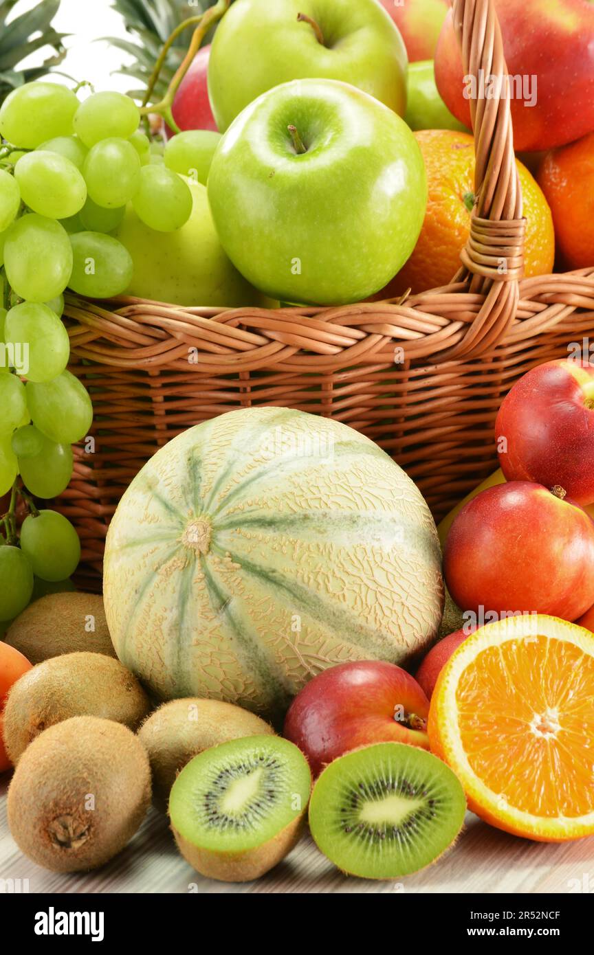 Composition with assorted fruits in wicker basket isolated on white ...