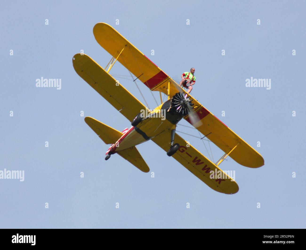 A Boeing A-75L300 Stearman biplane of The Wing Walk Company in action ...