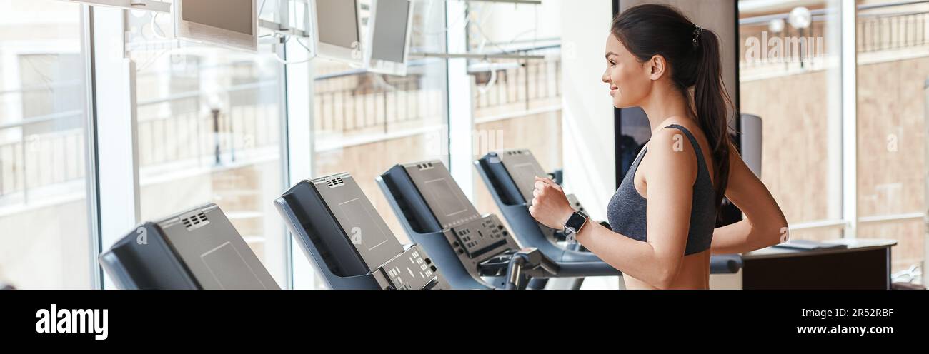 Body improvement. Side view of young and beautiful woman in sportswear ...