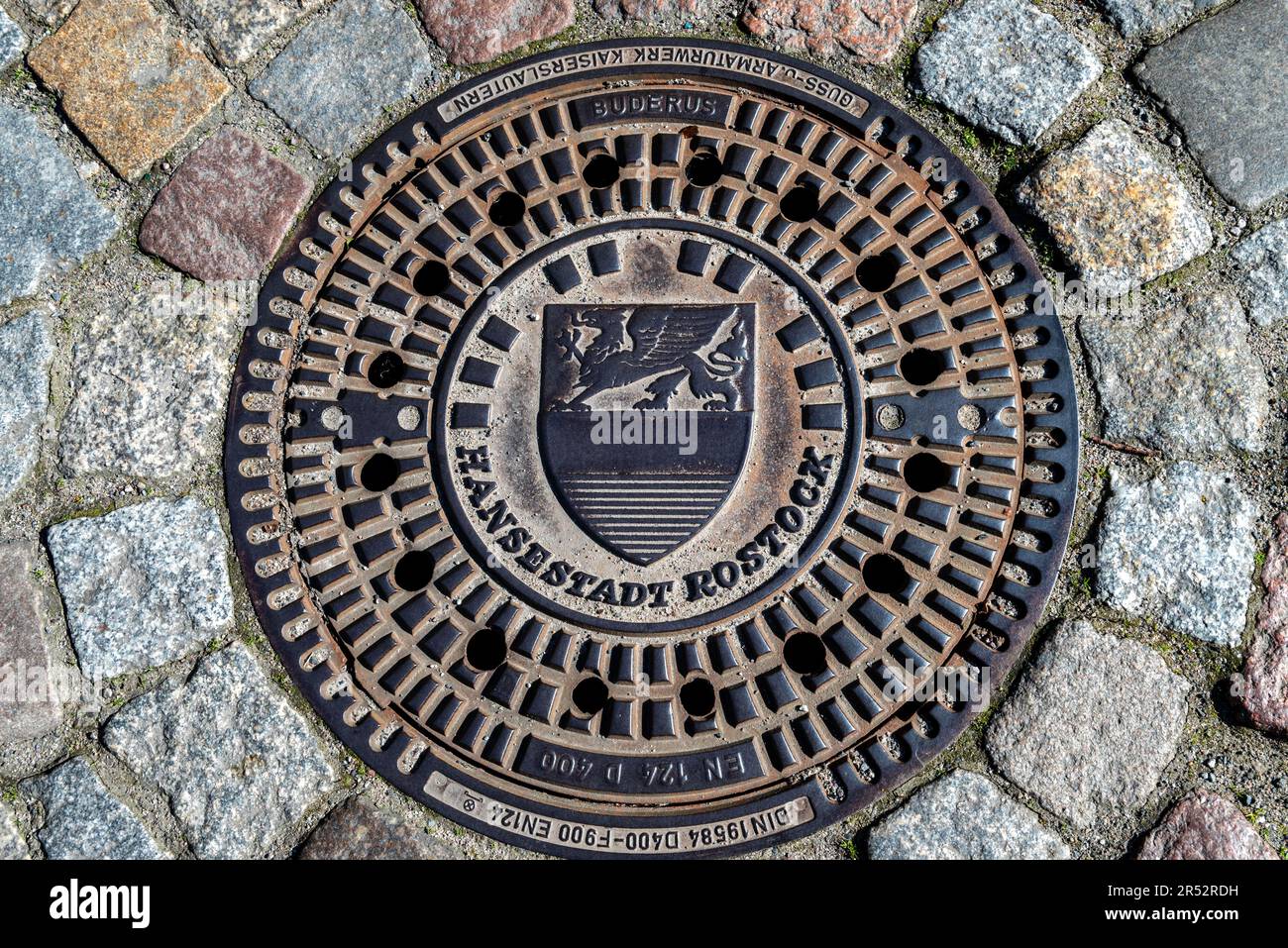 Gullideckel, manhole cover with city coat of arms in the pavement of ...