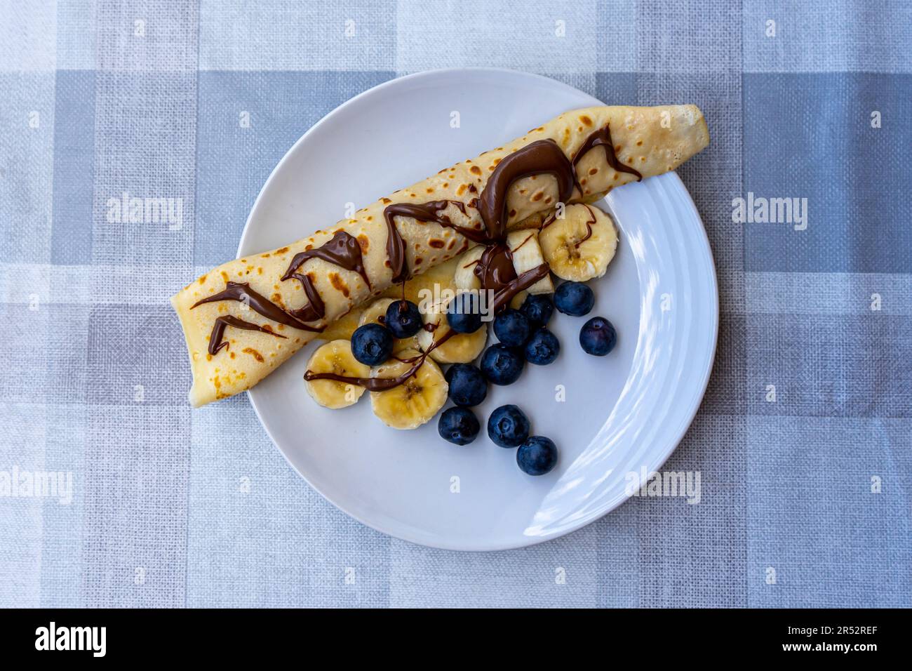 Traditional Ukrainian pancakes with bananas, chocolate and blueberry ...