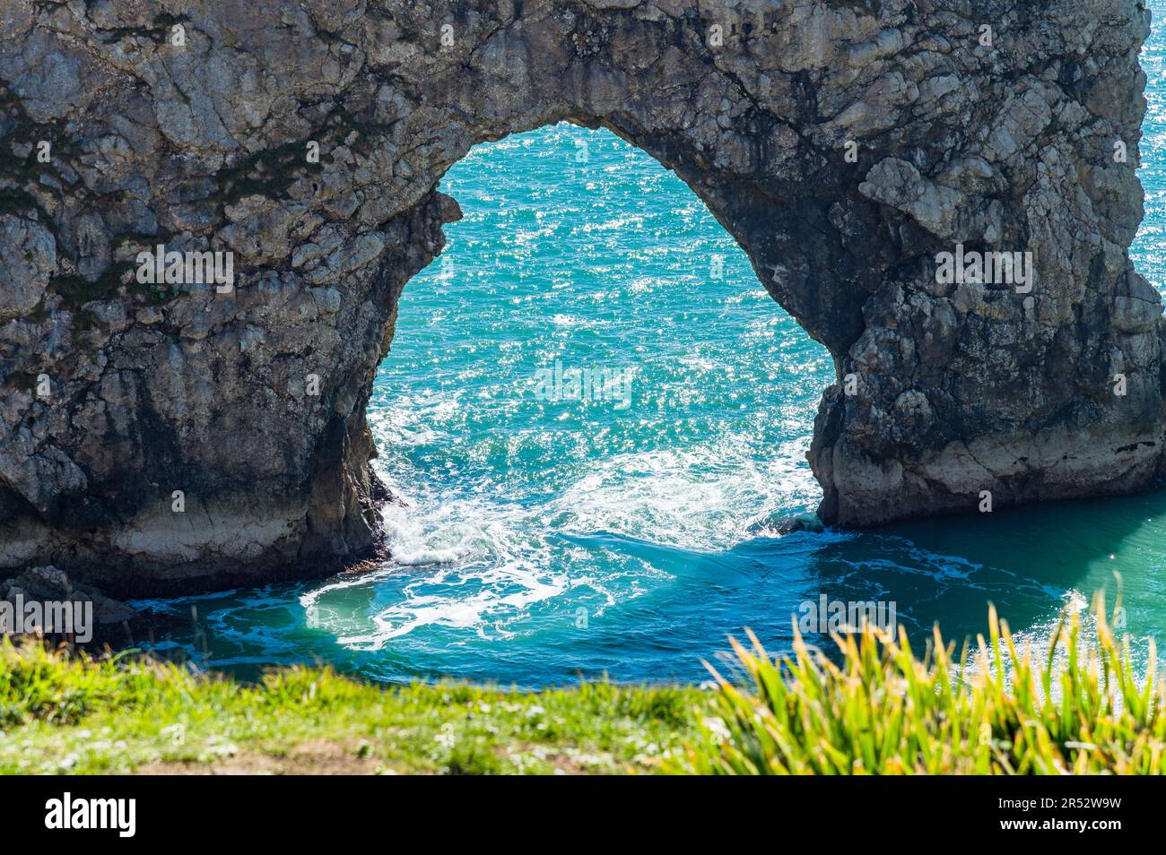 Durdle Door natural stone arch, Dorset, England, UK with sparkling blue ...