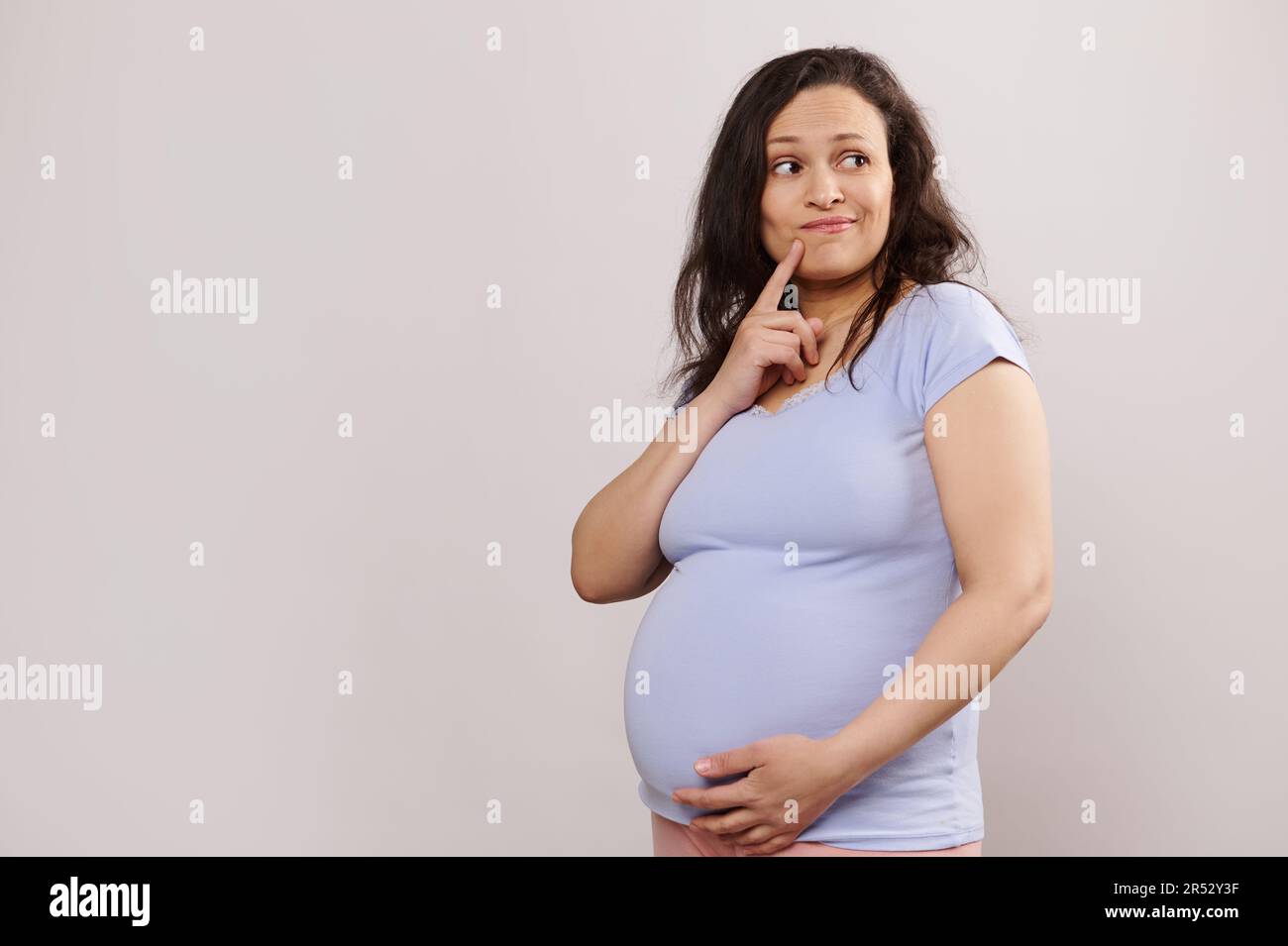 Pensive Multi Ethnic Pregnant Woman Thoughtfully Looking Aside Gently