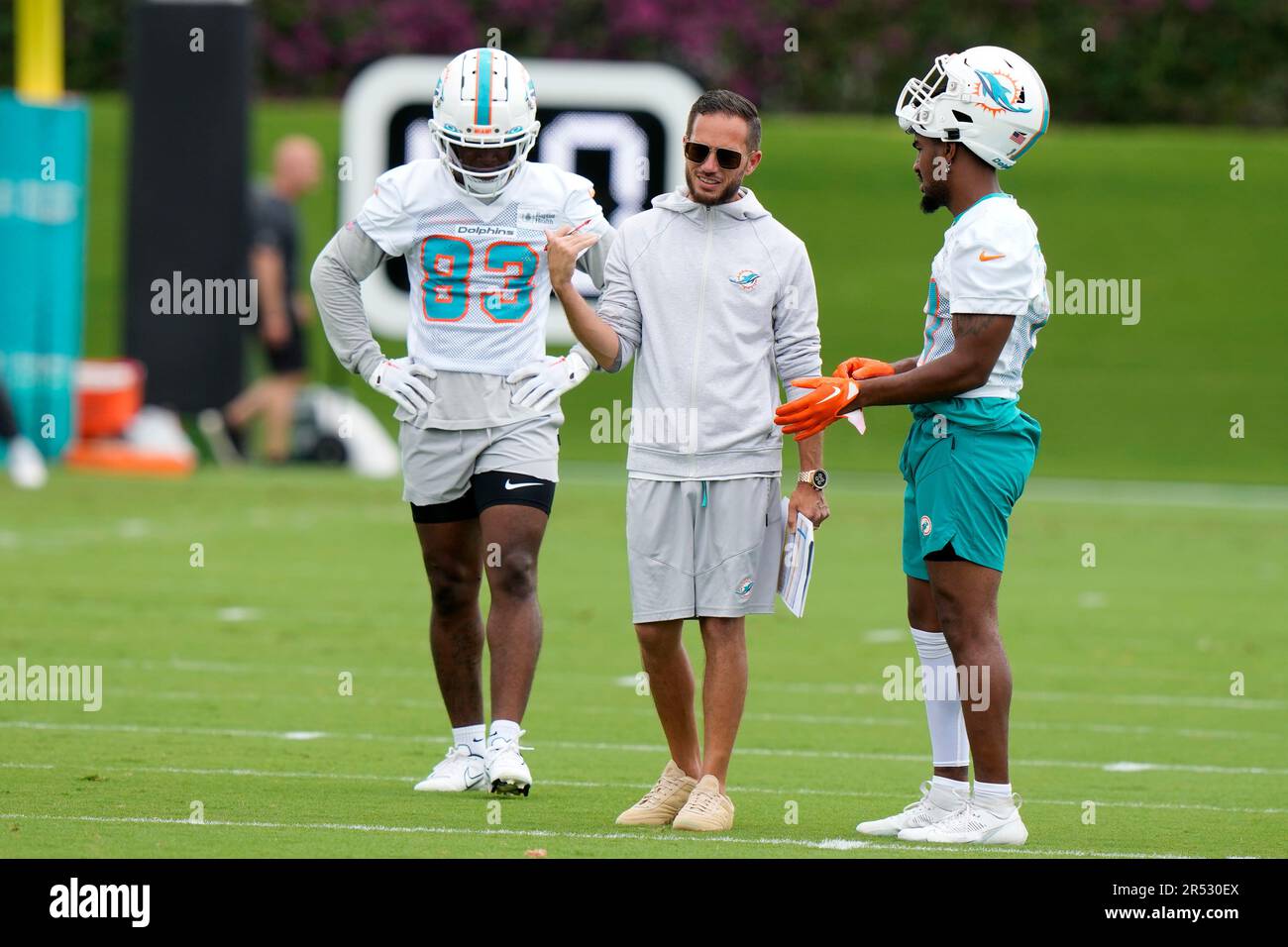 Miami Dolphins head coach Mike McDaniel, center, talks with wide ...