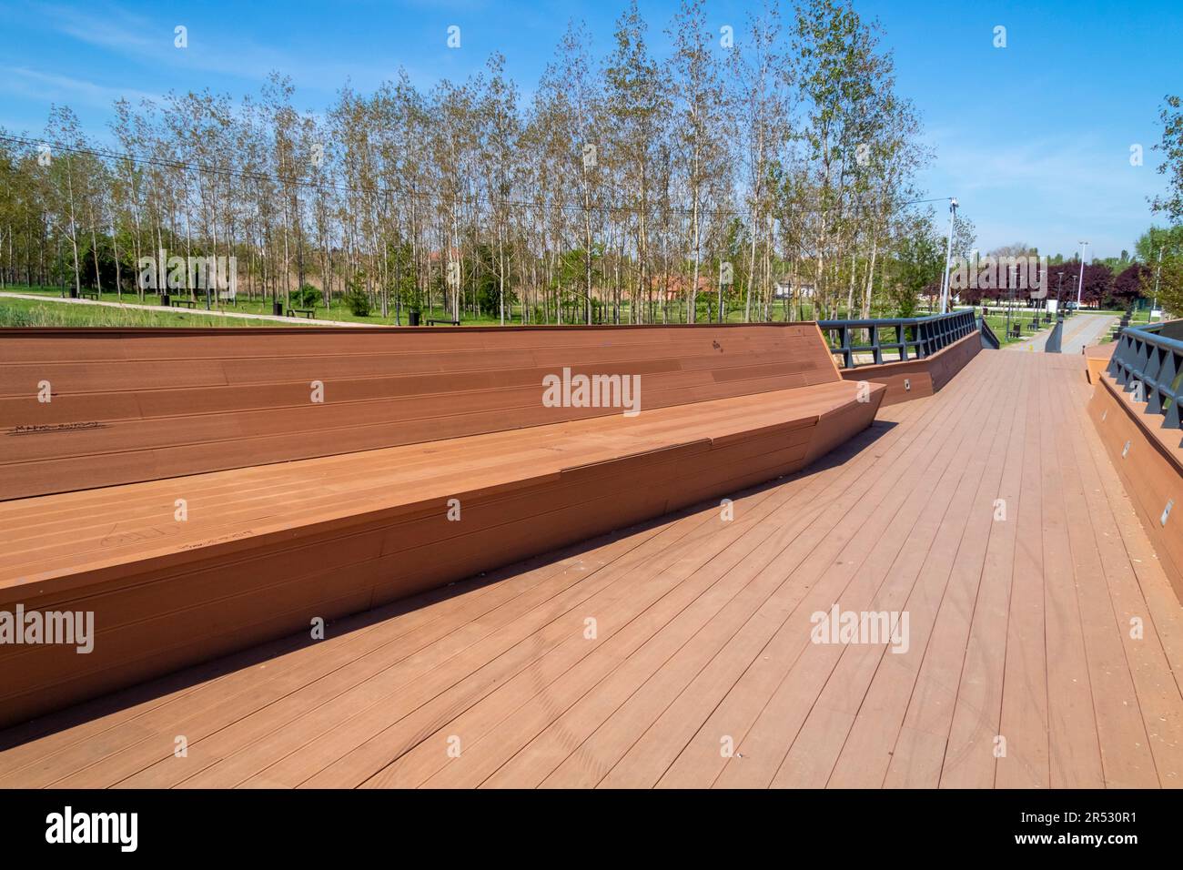 Wooden long park bench and path Stock Photo - Alamy