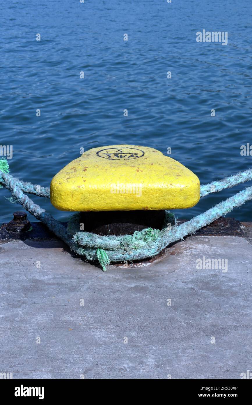 Yellow mooring bollard at the port Stock Photo - Alamy