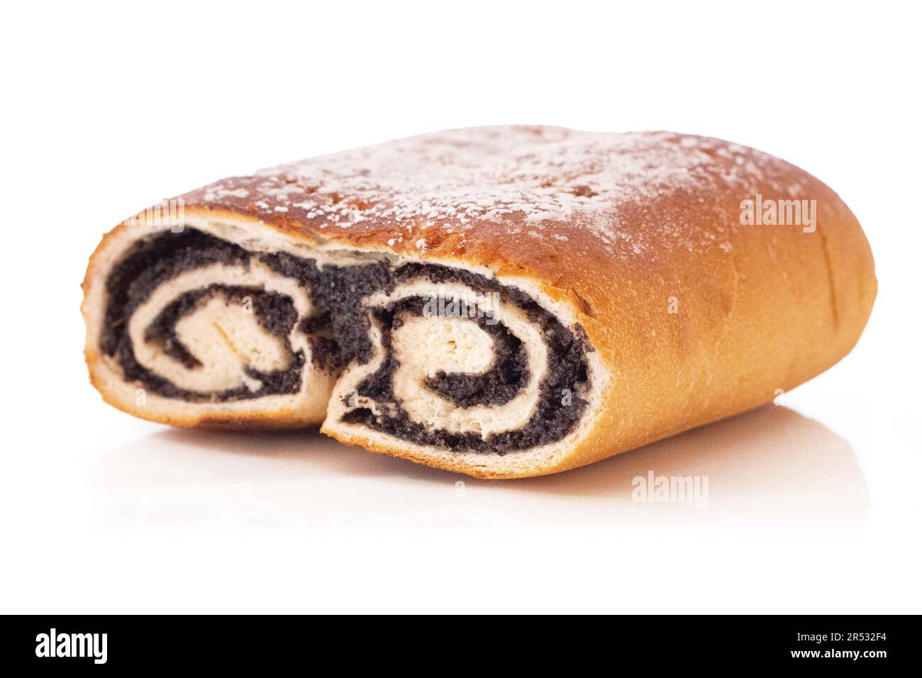 Large poppy seeds filled rolled pastry dessert with sugar icing ...