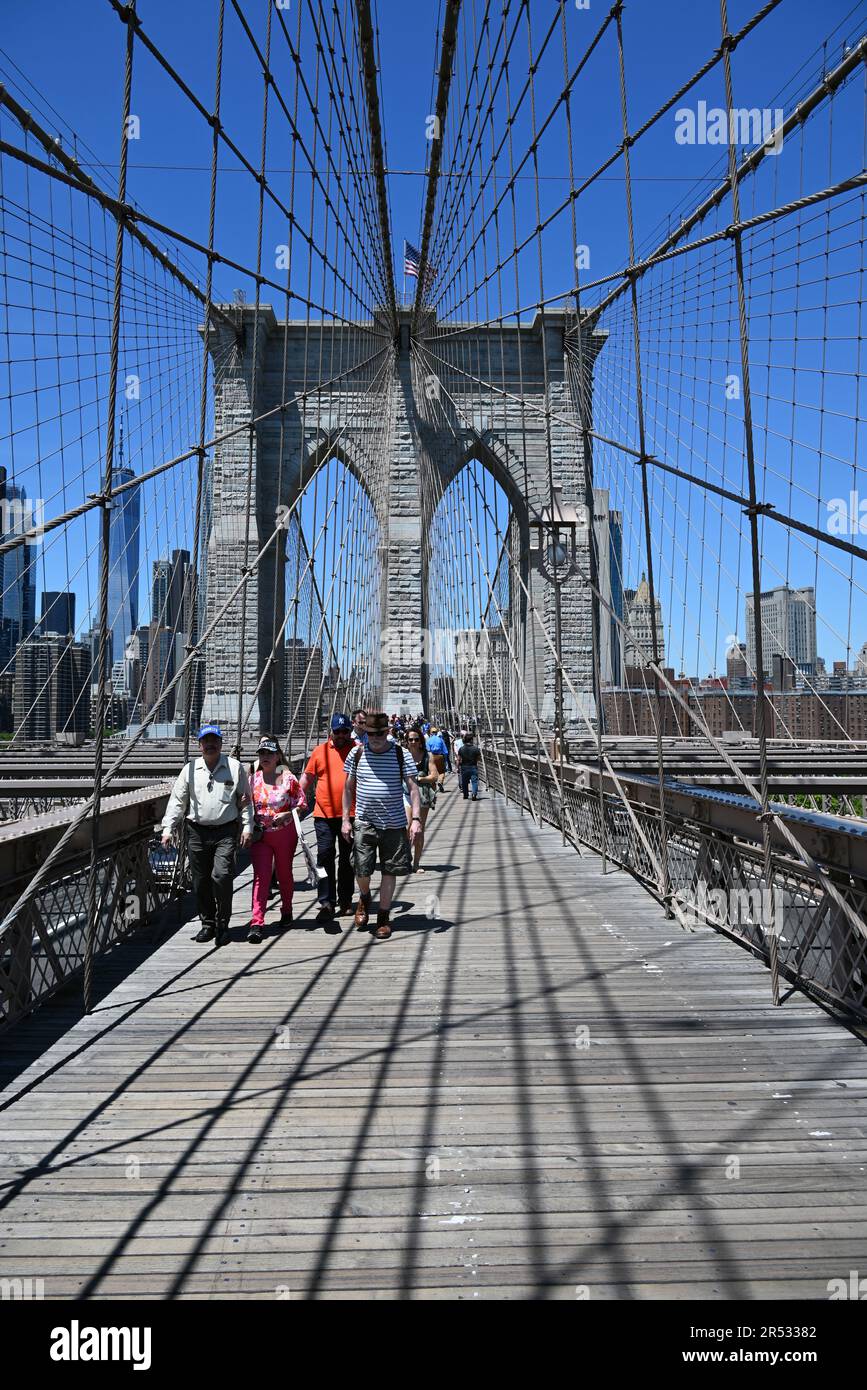 Visitors on the pedestrian walkway of the Brooklyn Bridge with the ...