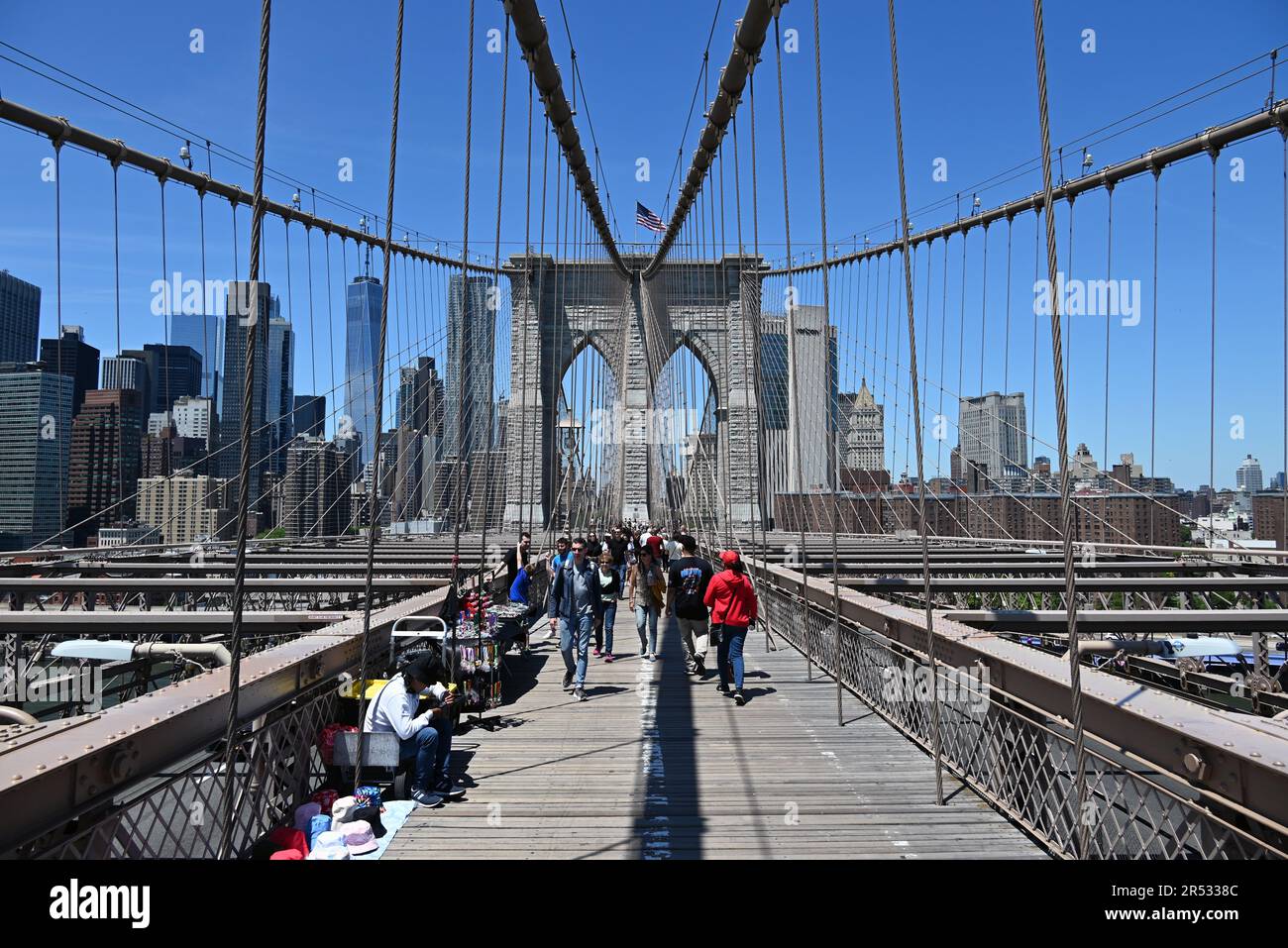Visitors on the pedestrian walkway of the Brooklyn Bridge with the ...