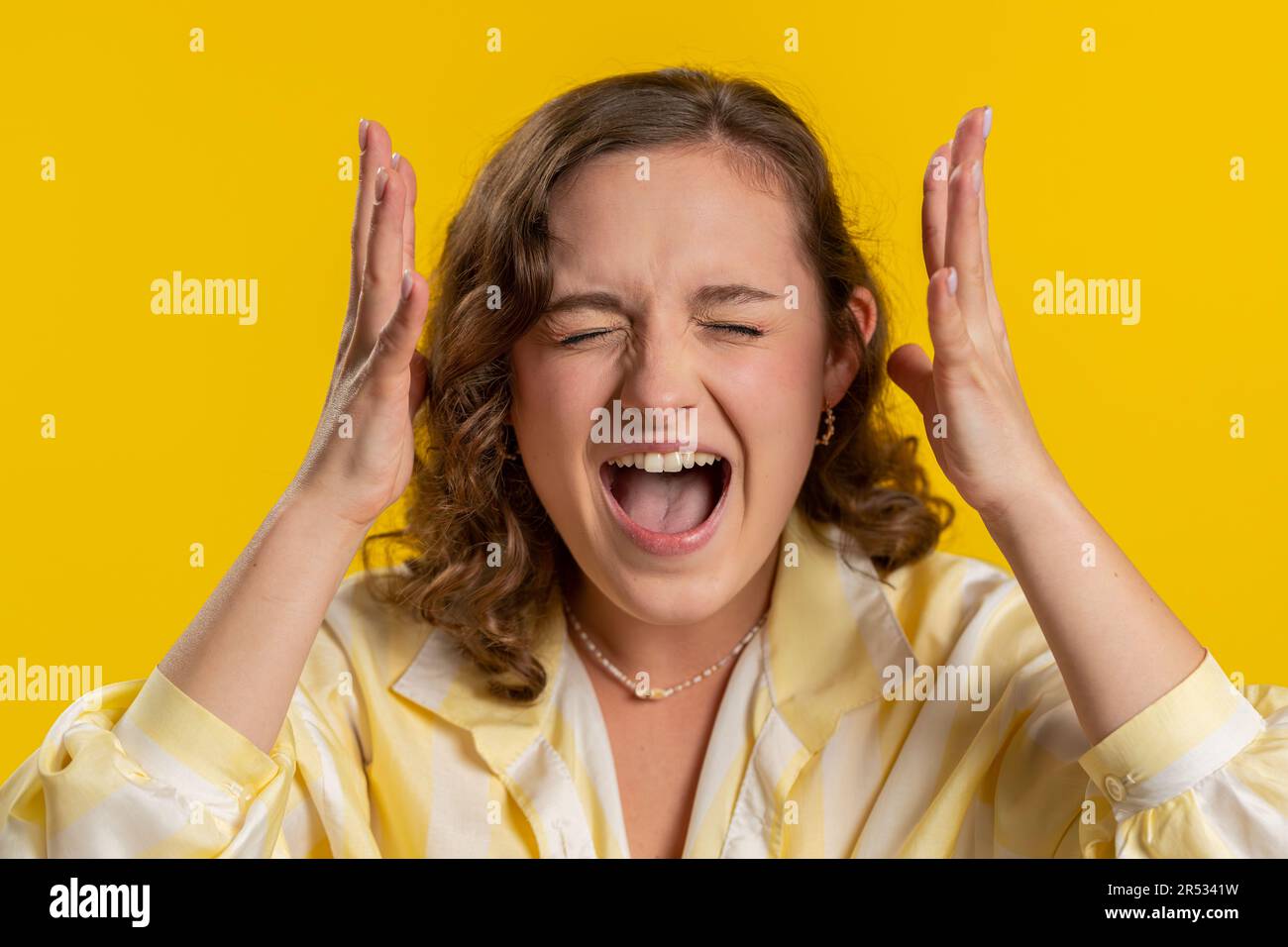 Young woman screams yell shout from stress tension problems feels ...