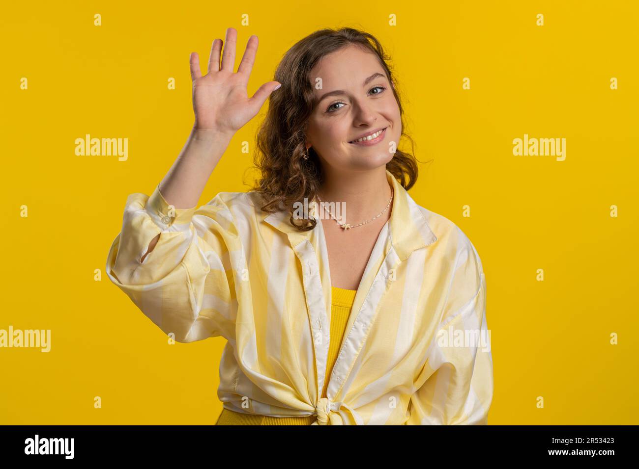 Come here, join us. Welcome. Brunette attractive woman showing inviting ...