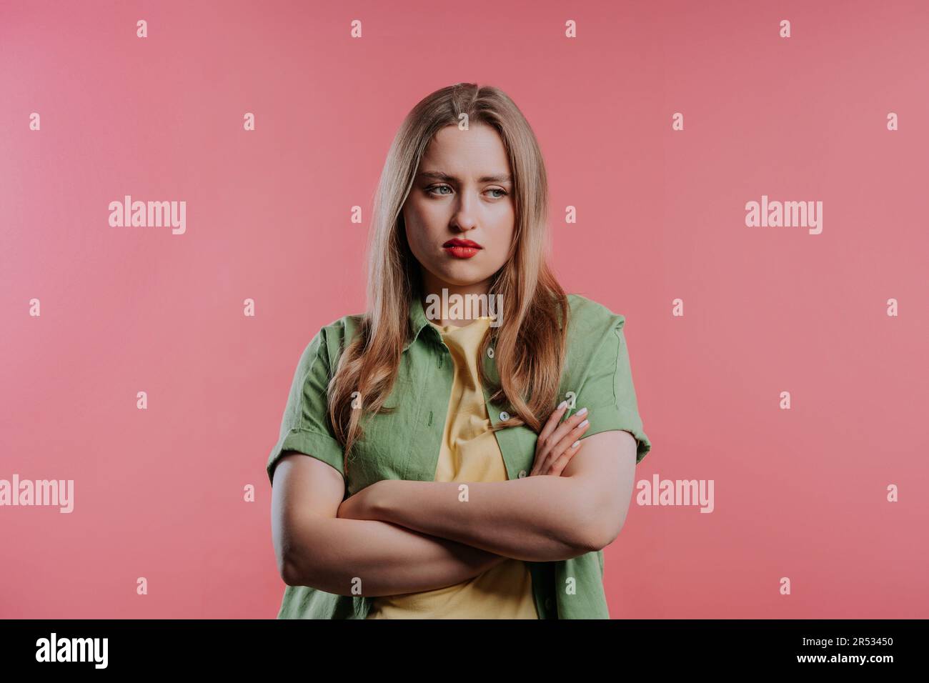 Offended young woman, arms crossed, feeling mad. Teen maximalism.Pink ...