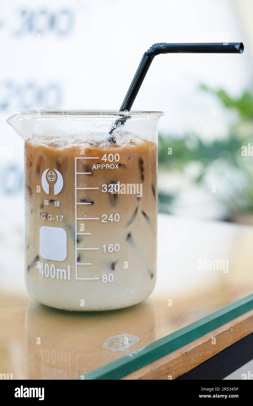 Iced coffee in a scientific beaker Stock Photo - Alamy