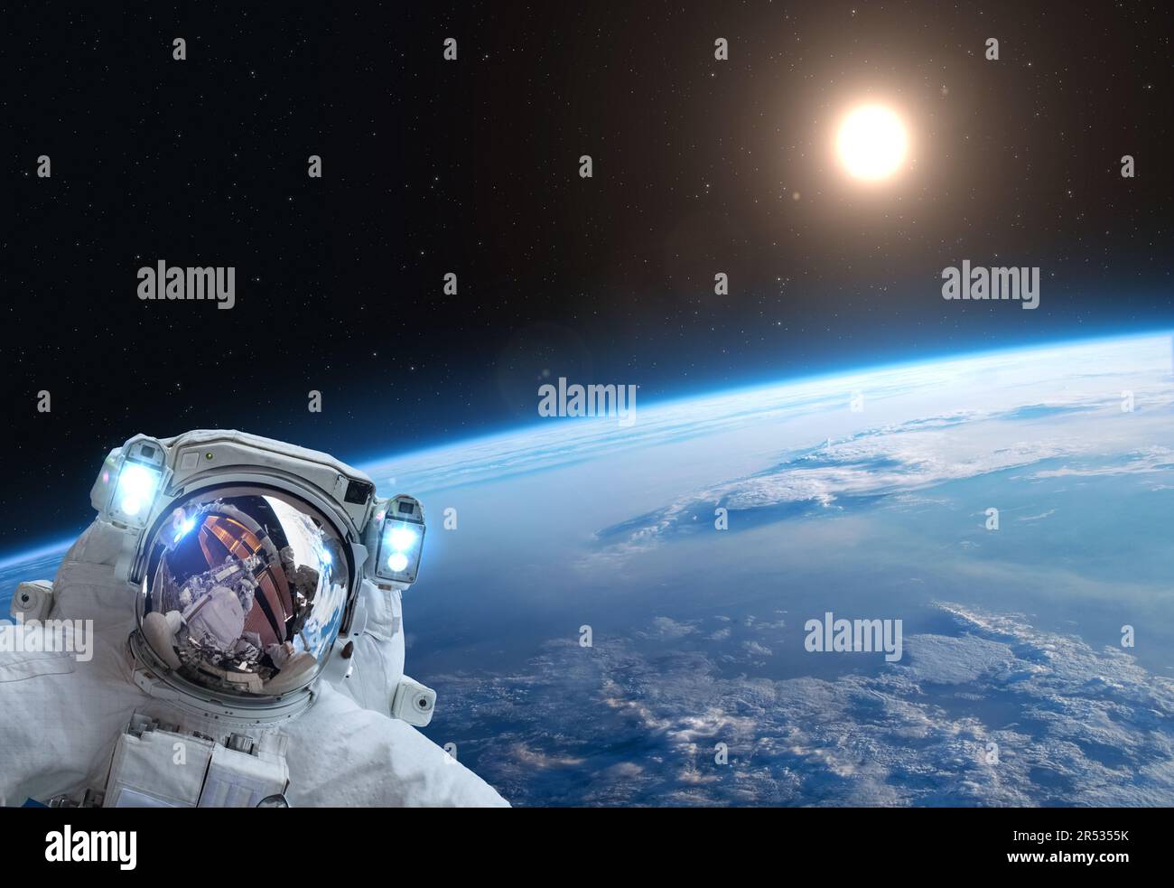 Astronaut at spacewalk over of the blue planet Earth. Science fiction ...