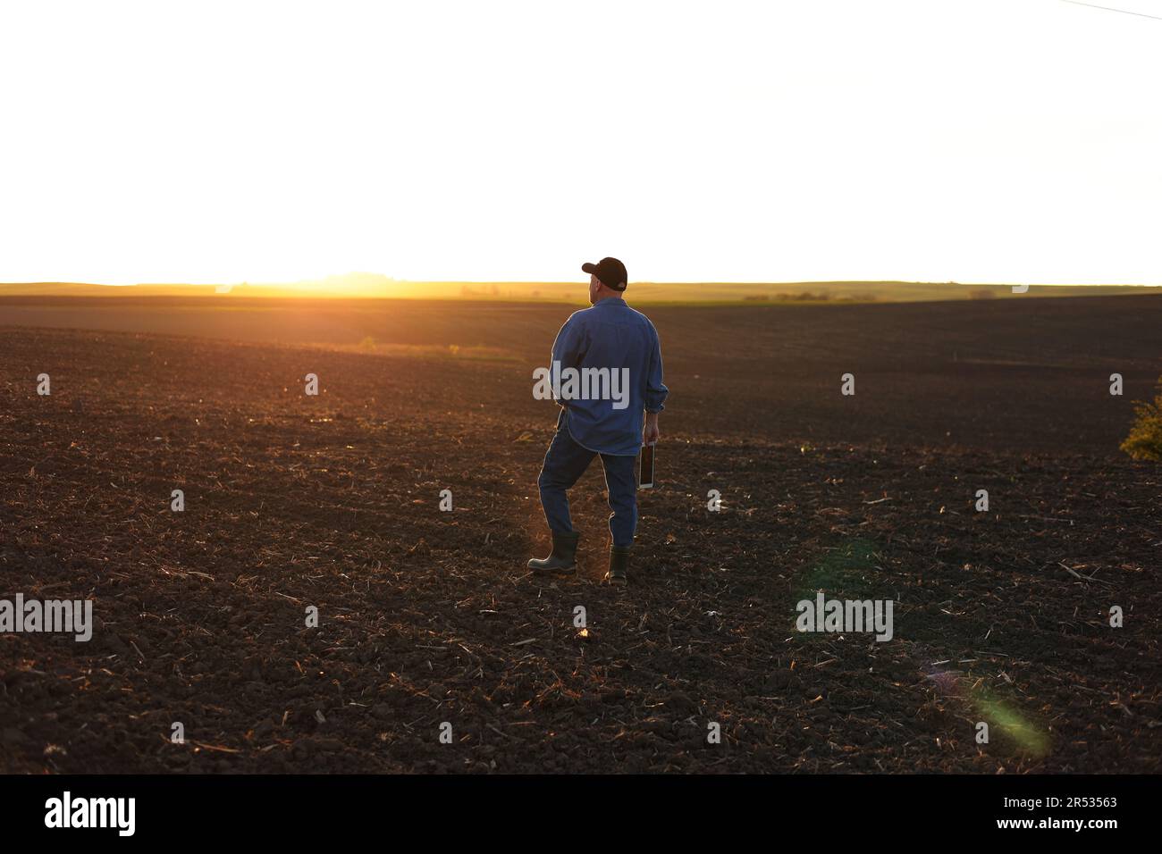 Farmer checking ground on plowed hi-res stock photography and images ...