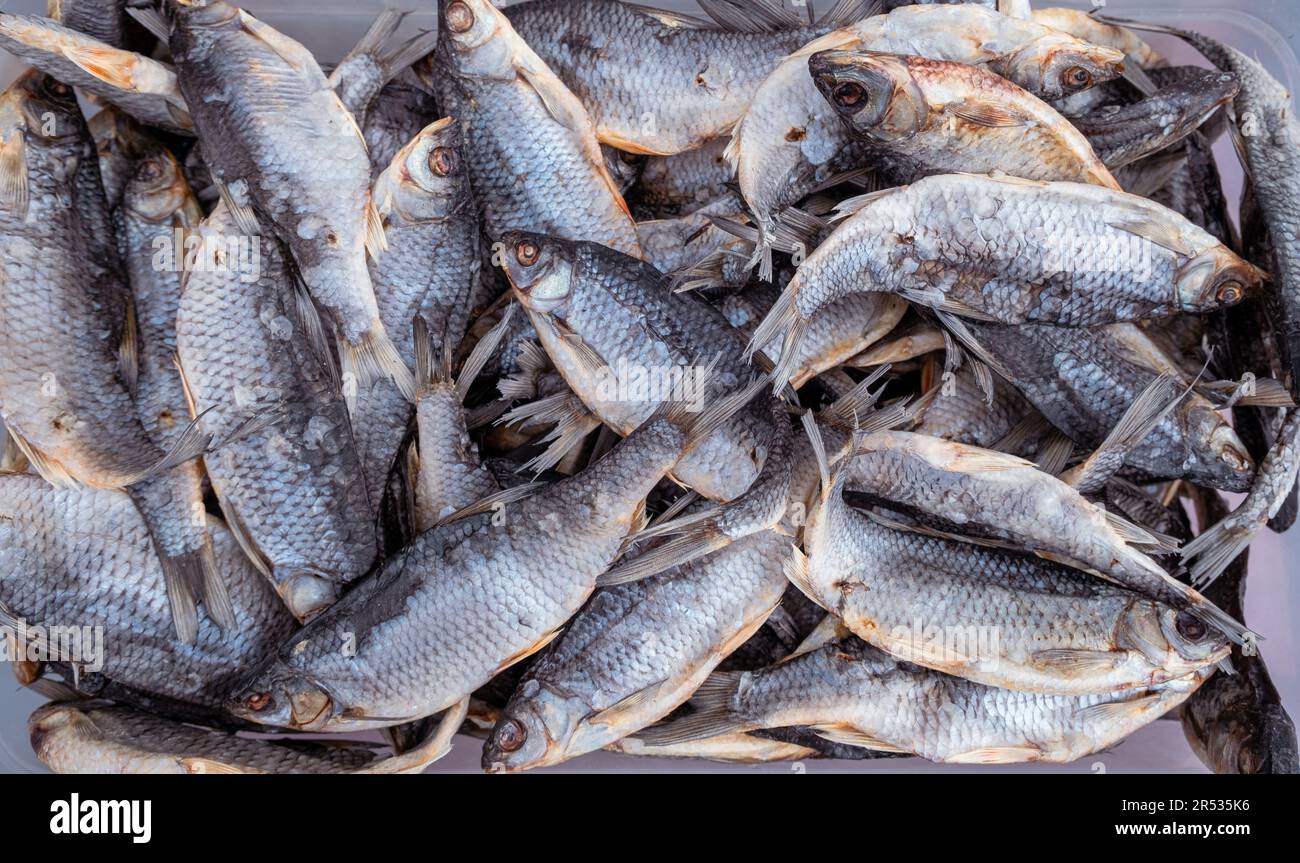 Lots of dried fish. Salty, dry river fish in a big pile. View from the ...