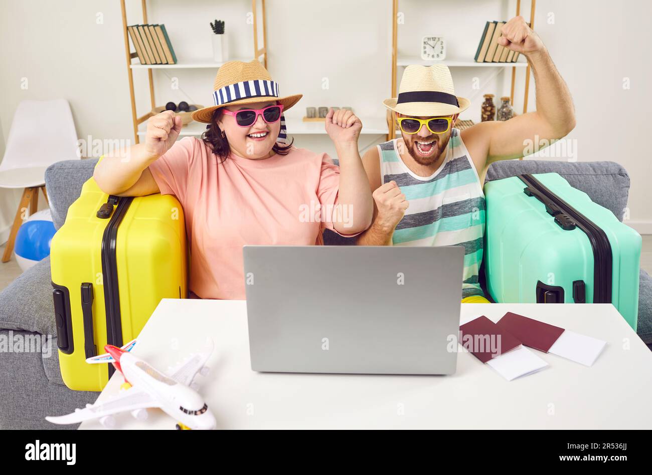 Happy family couple using laptop and booking holiday tour with cool ...