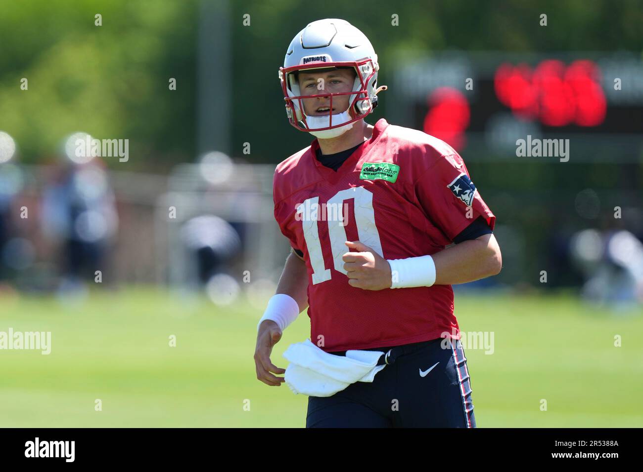 New England Patriots quarterback Mac Jones runs on the field during an ...