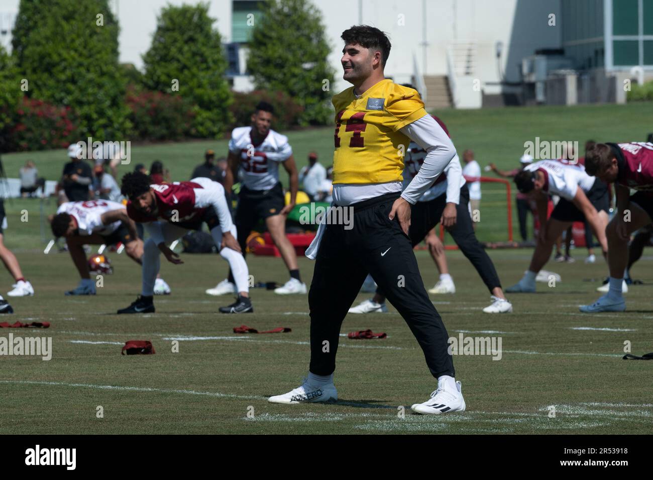 Washington Commanders quarterback Sam Howell stretches during the team ...